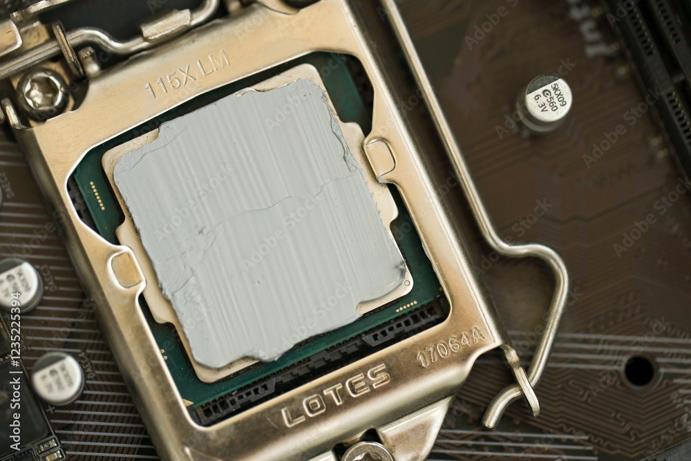 KYIV, UKRAINE - JANUARY 29, 2025 applying thermal paste on a processor for better cooling ...