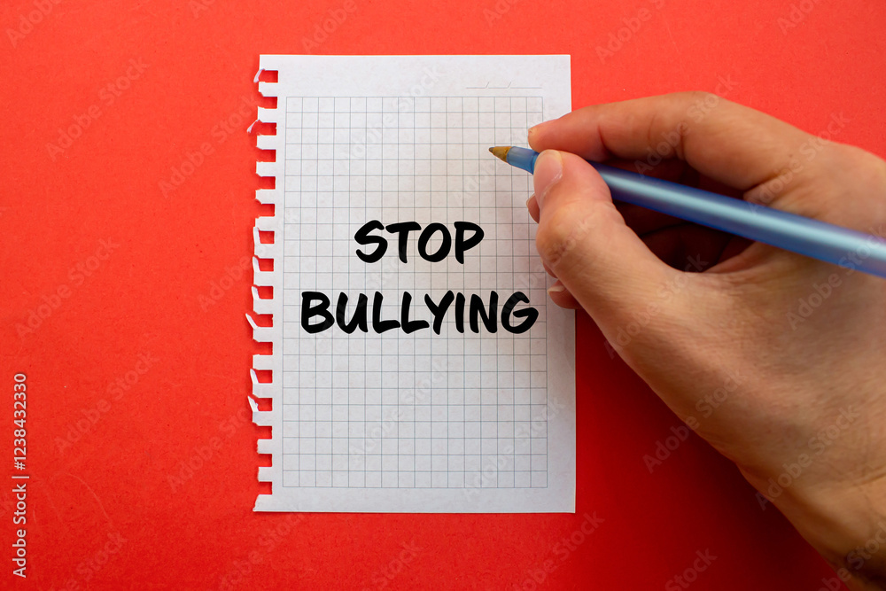 Stop bullying message written on white paper on red background ...