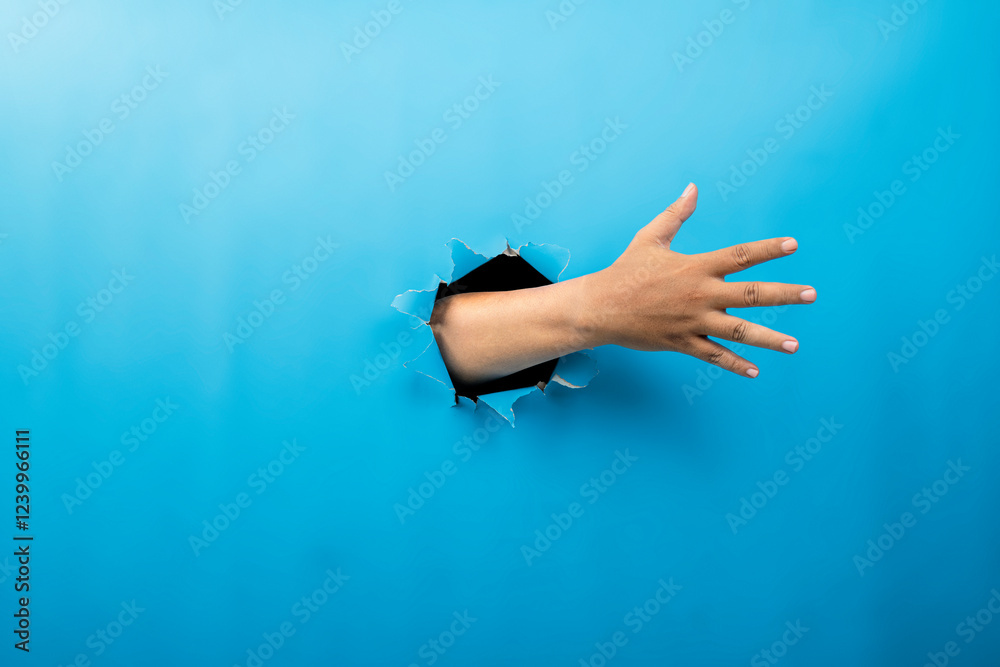 Human hand showing from ripped paper. Hand gestures of rejection or ...