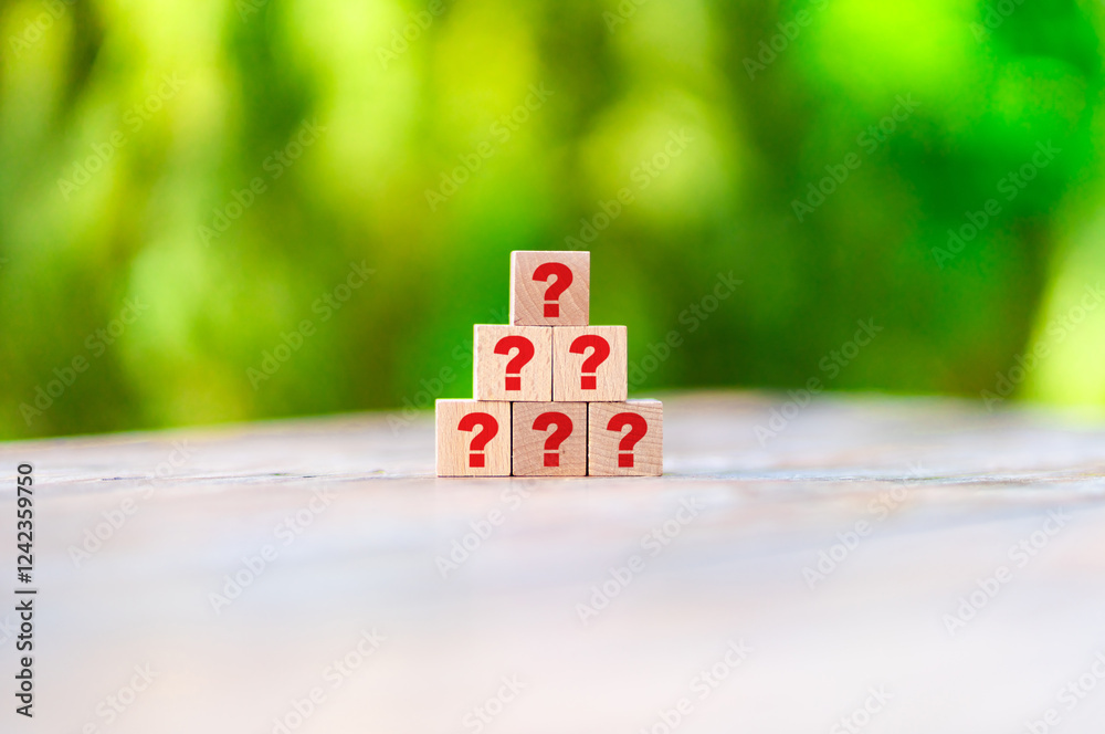 Wooden blocks with red question marks stacked in a pyramid shape on a ...