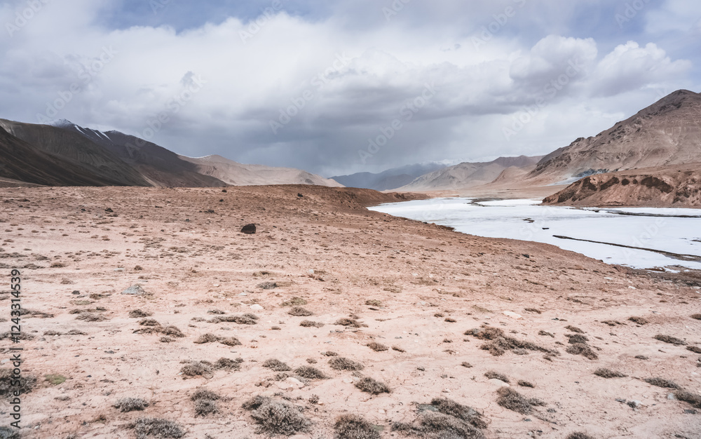 Snow lies in the valley in the highlands of Tien Shan in Pamir in ...