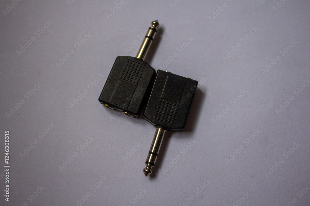 A stereo Akai jack adapter to two Akai mono jacks is photographed on a ...