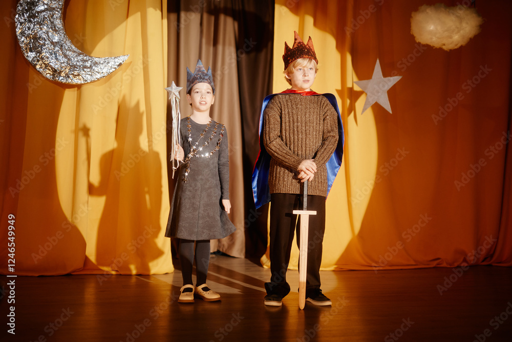 Children dressed in medieval-themed costumes performing on a stage with ...