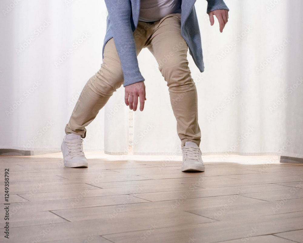 Young guy dancer in motion in a pose. A man performs a modern dance in ...