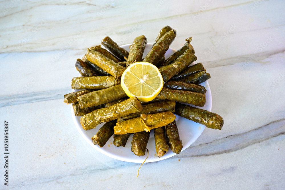 Delicious dolma (sarma) stuffed grape leaves rice, white yogurt sauce ...