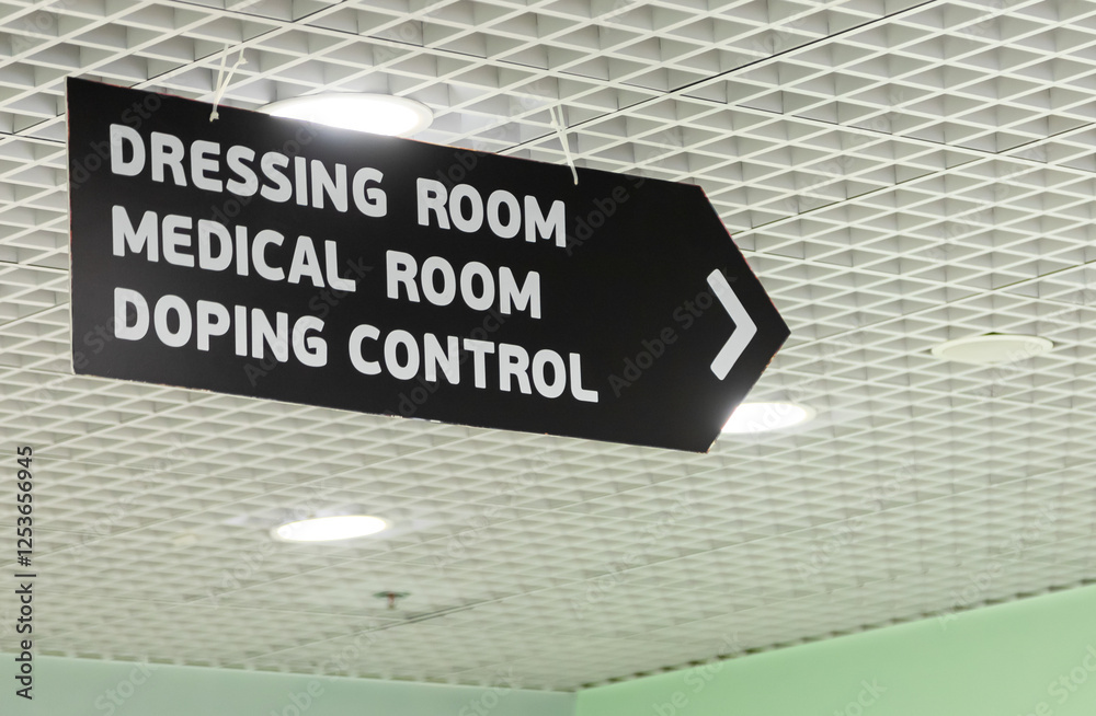 Sign directing visitors towards dressing room, medical room, and doping ...