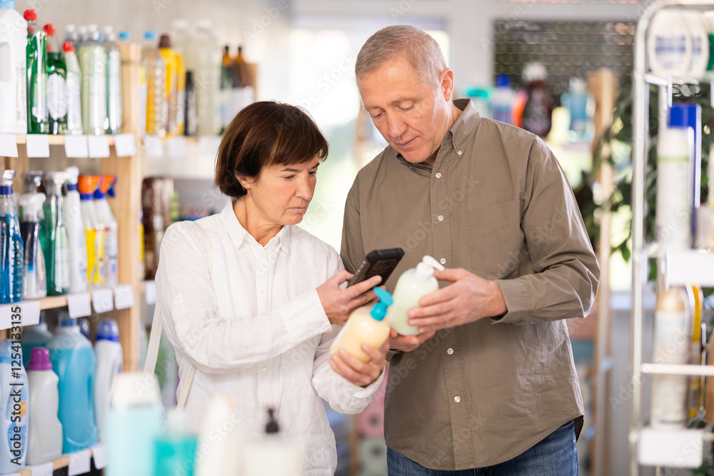 Elderly wife scans a barcode on mobile and shows her husband product ...