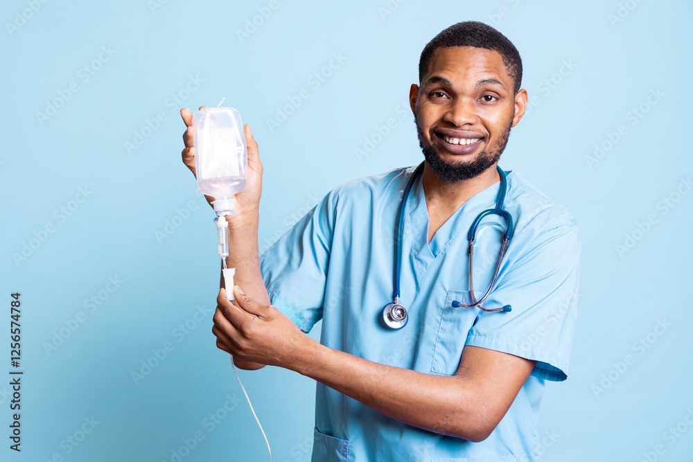 Male nurse holding IV bag, preparing to use it to administer fluids ...