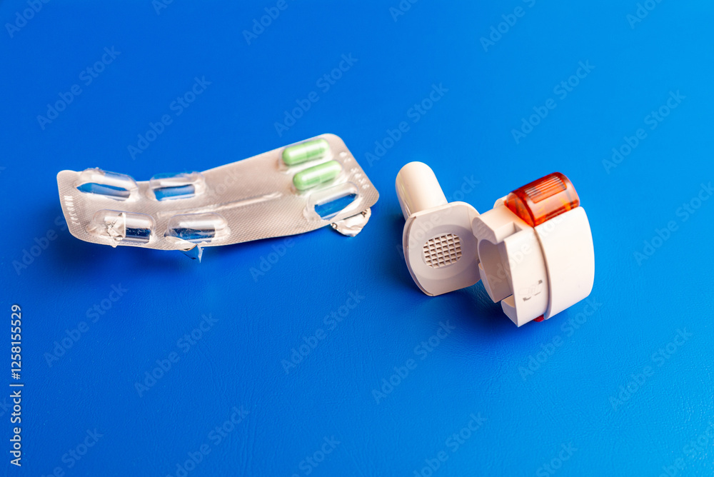COPD or Asthma medication instruments a capsule Inhaler on blue ...