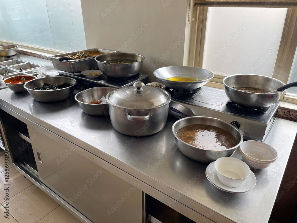 Indonesian padang restaurant menu, Multiple pots and bowls filled with ...