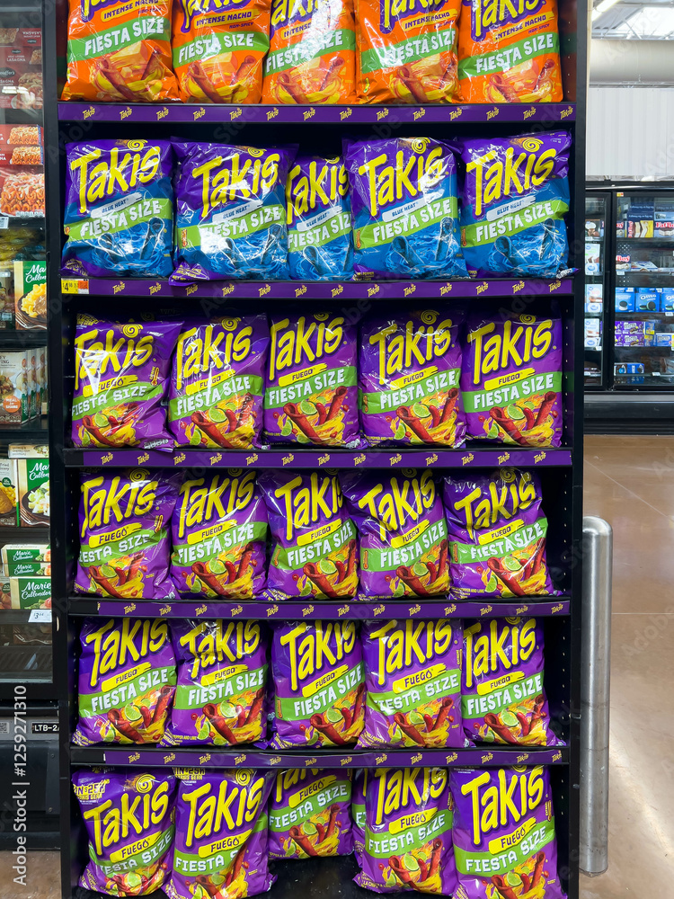 Bags of Takis brand snacks for sale at a supermarket shelf. Takis are a ...