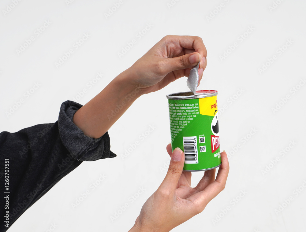 Jakarta, Indonesia - February 1st, 2025 - Hand opening Pringles sour ...
