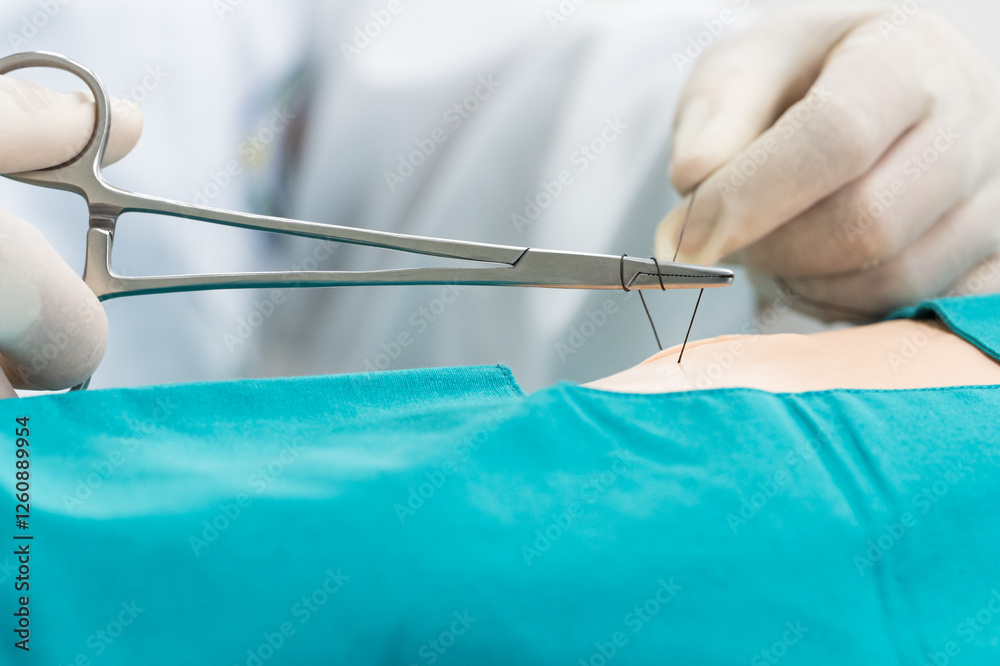 Doctor hand wear sterile gloves and surgery scissor stitching up wound ...