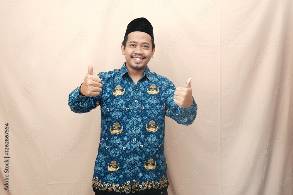 Handsome Indonesian government worker man wearing batik korpri uniform ...