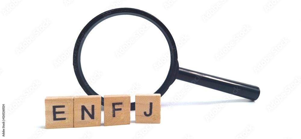 Wooden blocks with ENFJ letters, and a magnifying glass. ENFJ is one of ...