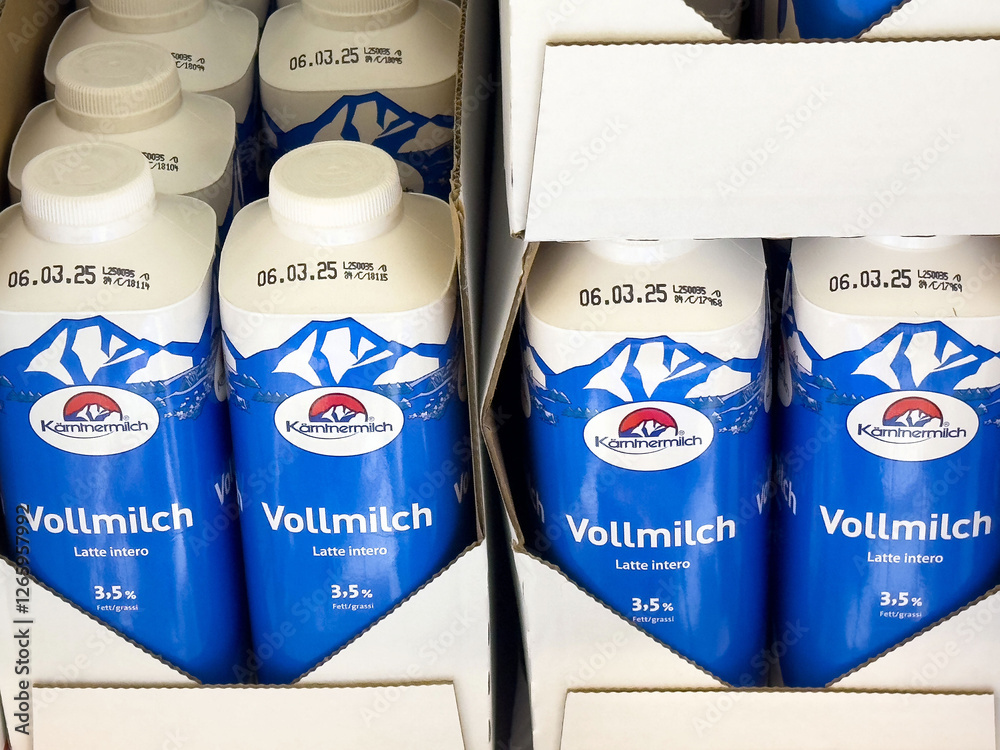 Full cream milk cartons in display box with european mountain logo and ...