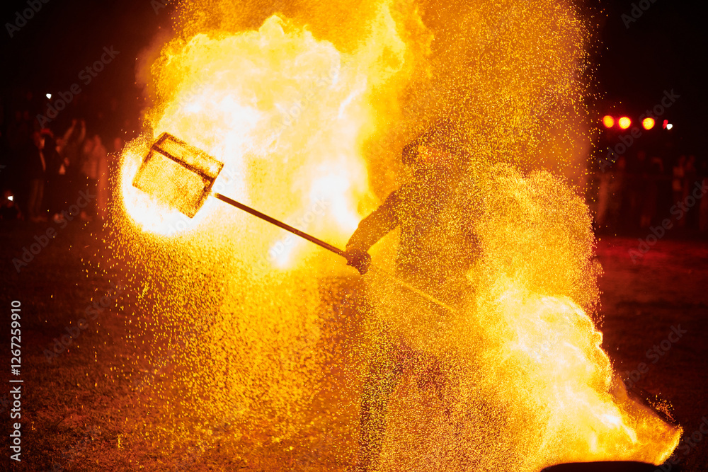 Silhouette of two fire performers with sparkling fire staff erupting in ...