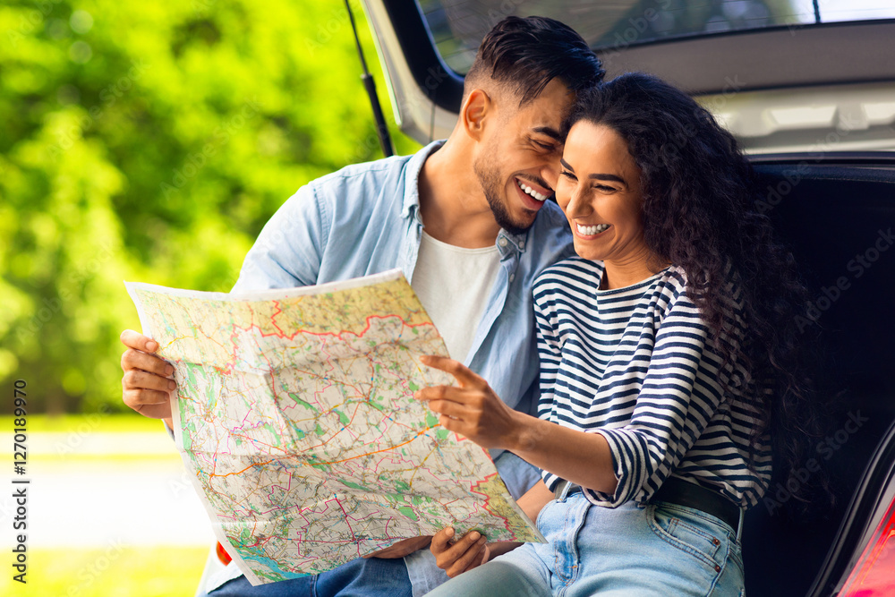 Foto de Stock Happy young lovers cuddling while sitting on auto trunk ...