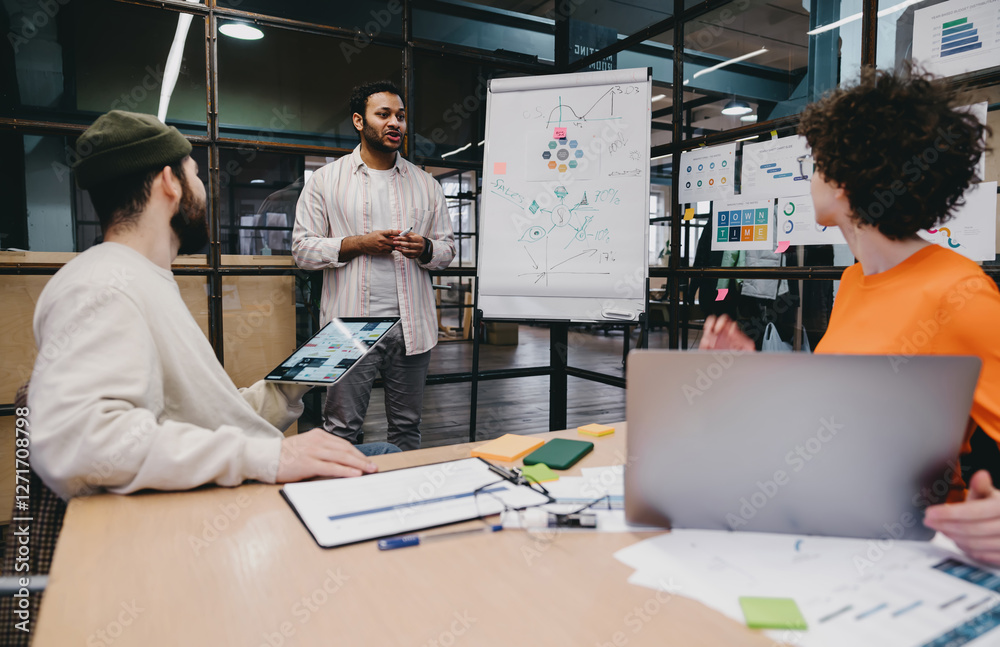 Male architect presenting project to colleagues in office Stock Photo ...