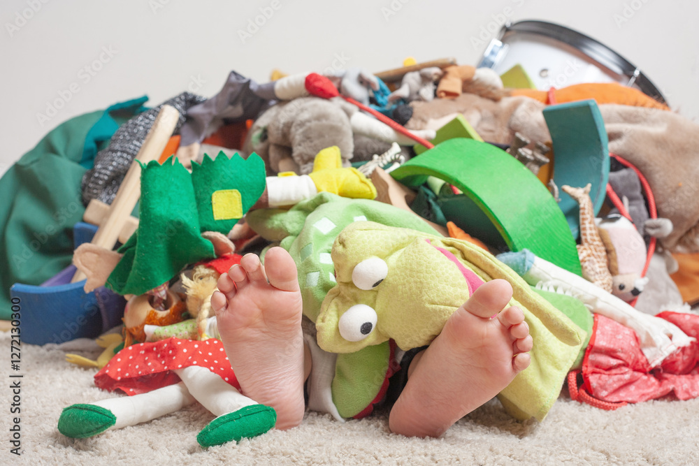 Mountain of toys with a child's feet sticking out from under it Stock ...