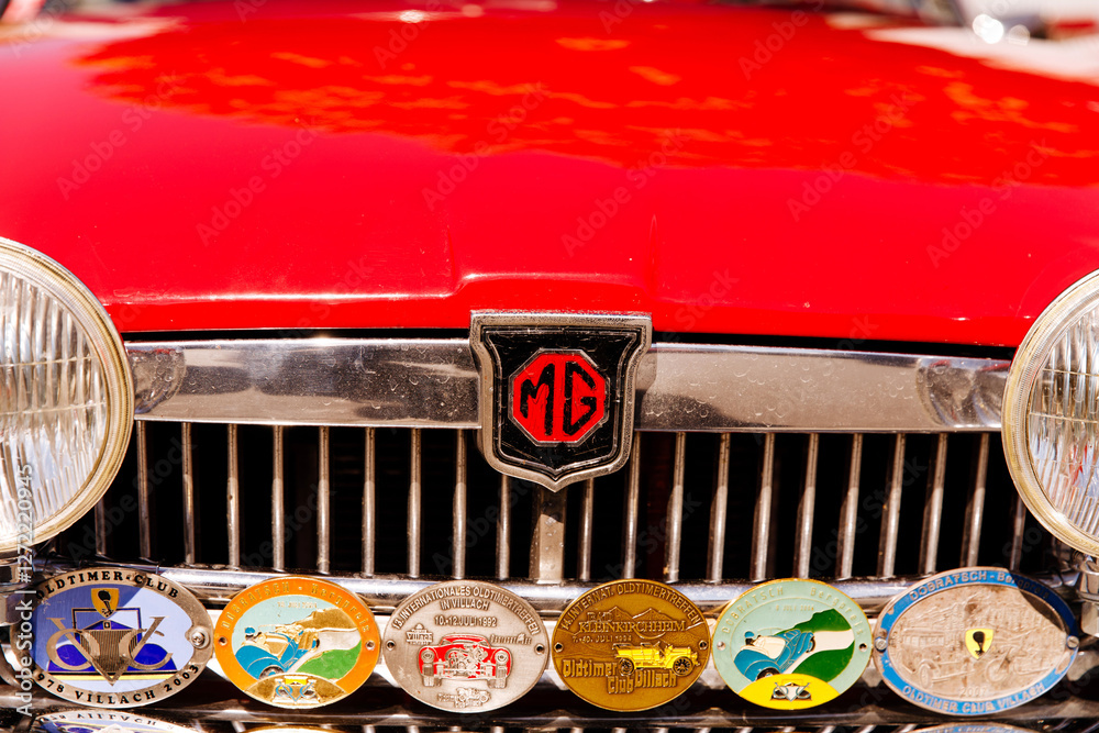 Classic red mg car front grille with vintage badges display, oldtimer ...