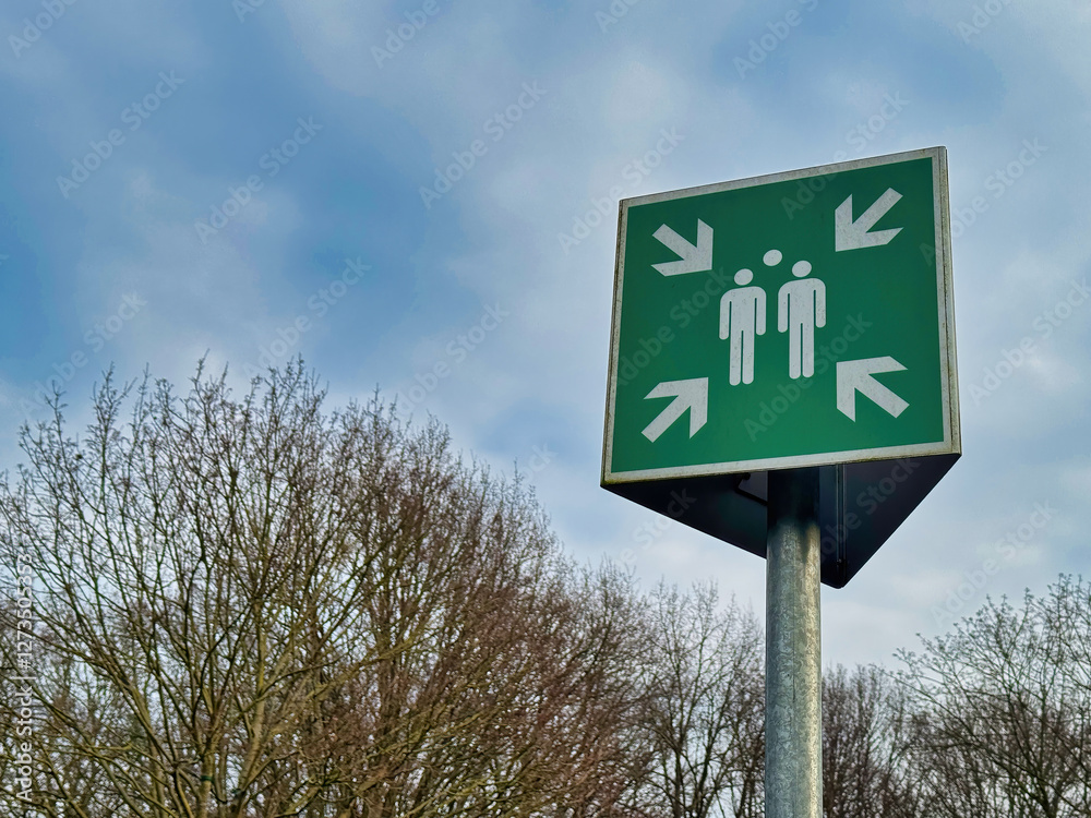 Muster station sign high on a post with trees in background Stock Photo ...