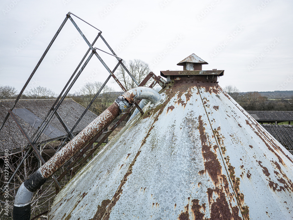 Drone inspection of an old and rusty grain feed silo located on a ...