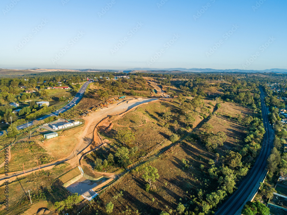 Machinery on worksite lined up in morning light ready to continue ...