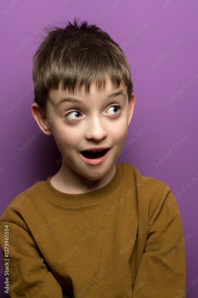 Child with surprised expression, mouth open, purple background. Great ...