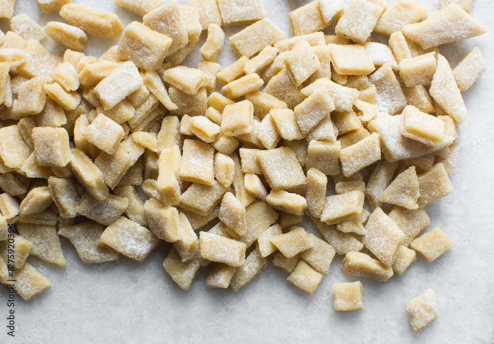 Nigerian Chin chin dough on a white granite countertop, Raw sliced chin ...
