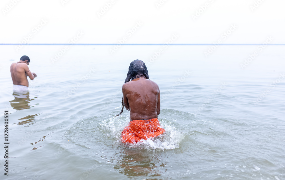 Mahakumbh, Portrait of holy male sadhu baba standing in holy river ganga to take holy dip during ...