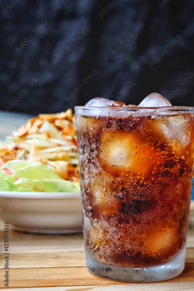 Cola soft drink with ice cubes and papaya salad spicy Thai food Stock ...