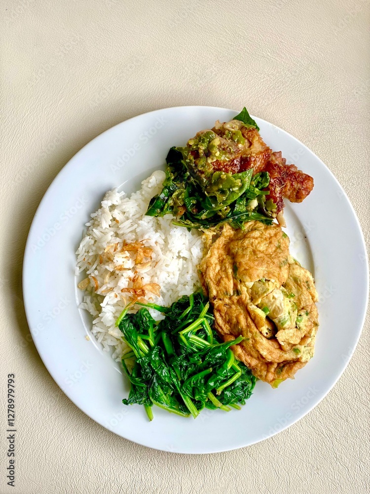 Nasi campur, a classic Indonesian dish featuring rice with an ...