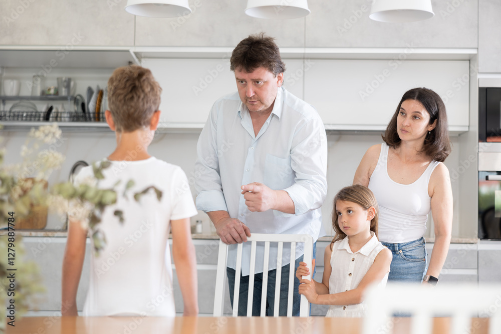 Foto de Stock Preteen boy being scolded by angry parents in the kitchen ...