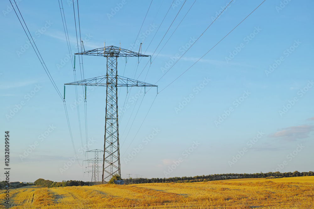 Electricity pylons, tower and countryside with blue sky, cables for ...