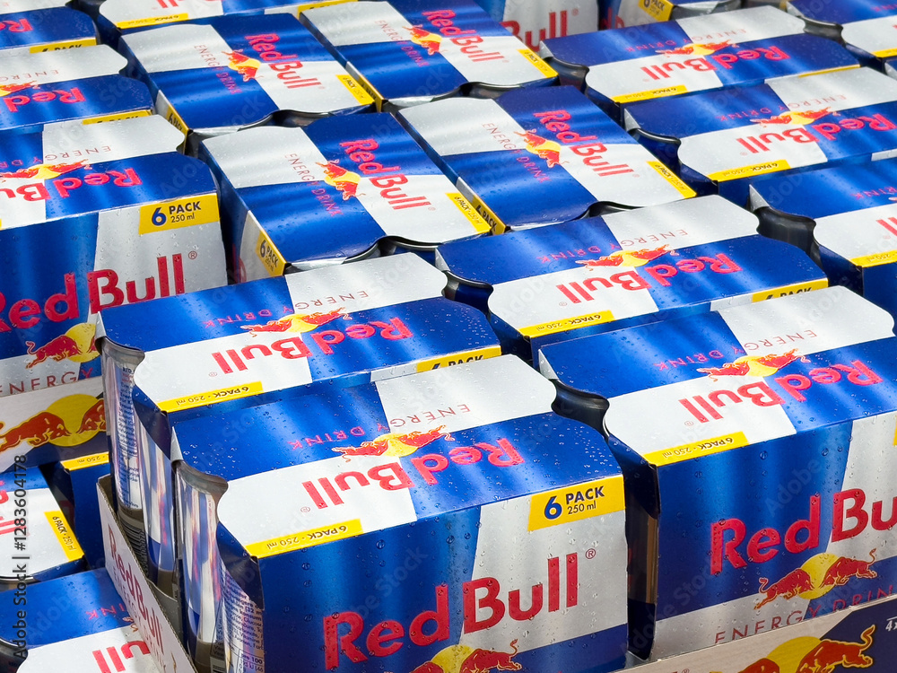 Stacks of red bull energy drink packs displayed in a store Stock Photo ...