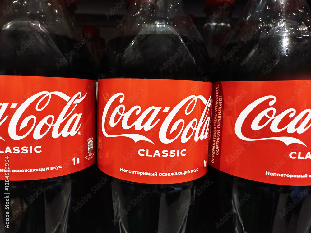 Rows of classic Coca-Cola soft drink bottles displaying the familiar ...