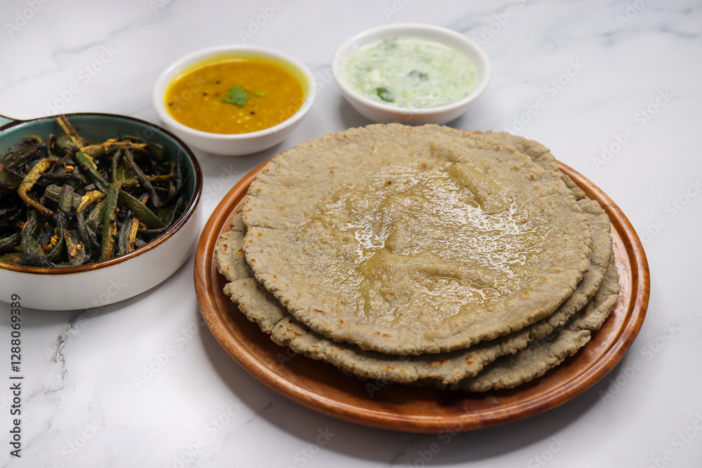 Roti and Sabzi. Indian vegetarian Thali includes bhindi fry, yellow ...