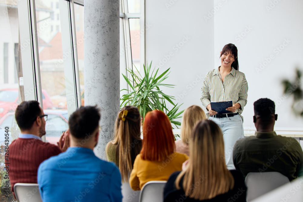 Woman Giving a Presentation to an Engaged Group in a Modern Setting ...