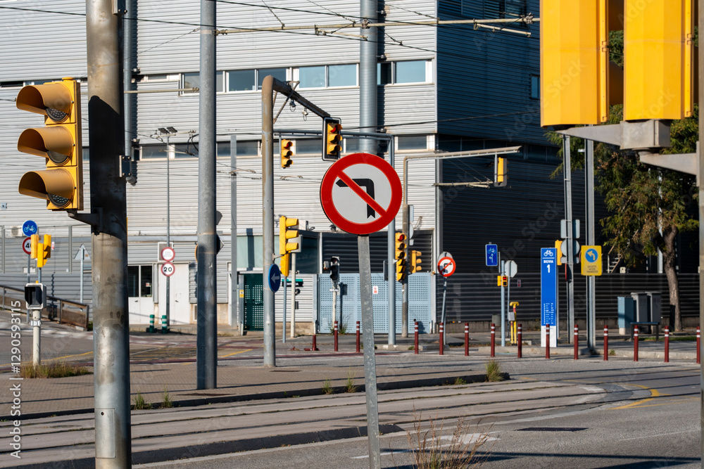 Urban intersection with traffic signs, road markings, and a modern city ...