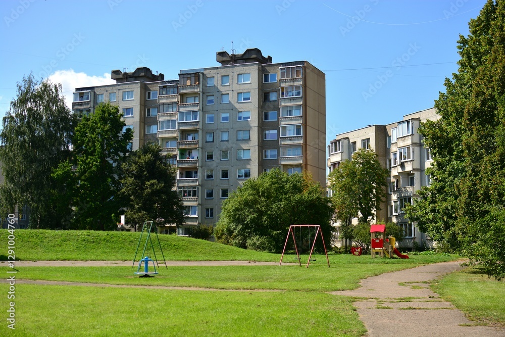 Children playground area near old soviet apartment houses in sunny ...