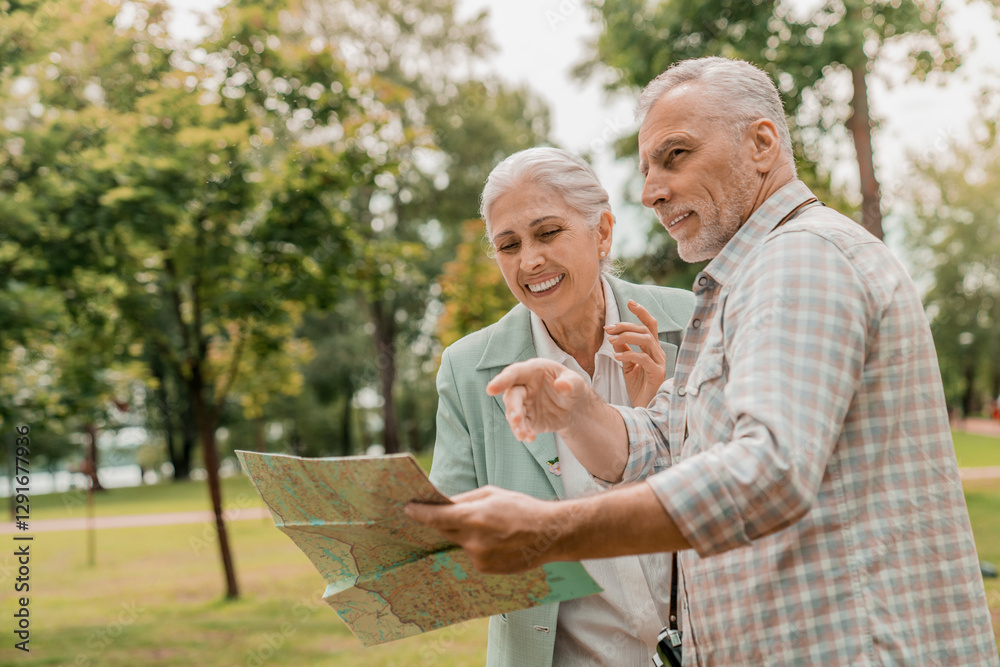 Happy man and woman elderly family friends looking watching map while ...