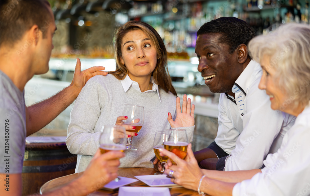 Diverse group having an awkward conversation at a bar with beer.. Stock ...