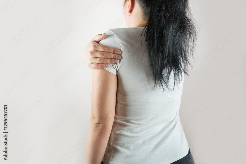 Shoulder pain. Woman suffering from shoulder pain. Muscle strain ...