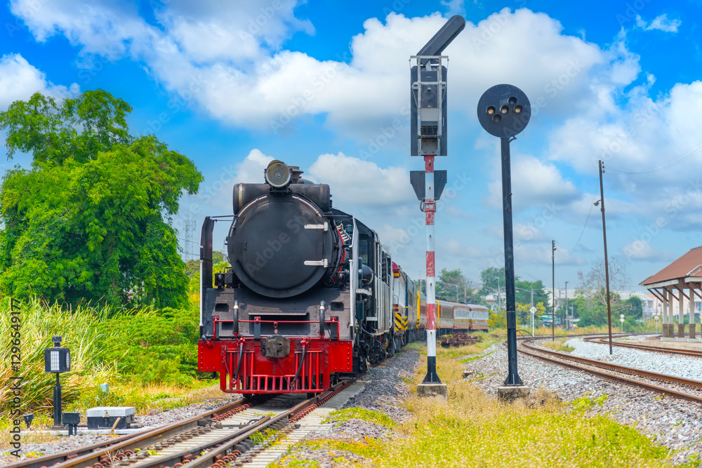 Vintage black steam locomotive train stands at the traffic light in ...