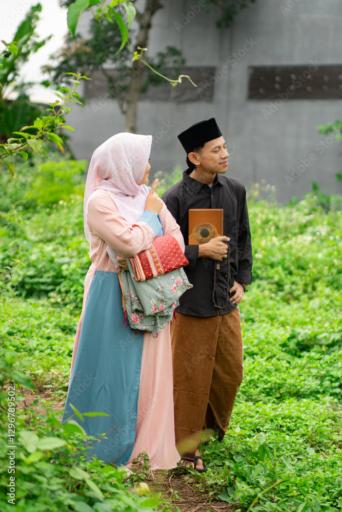 Muslim male students and Muslim female students wearing hijabs walk ...