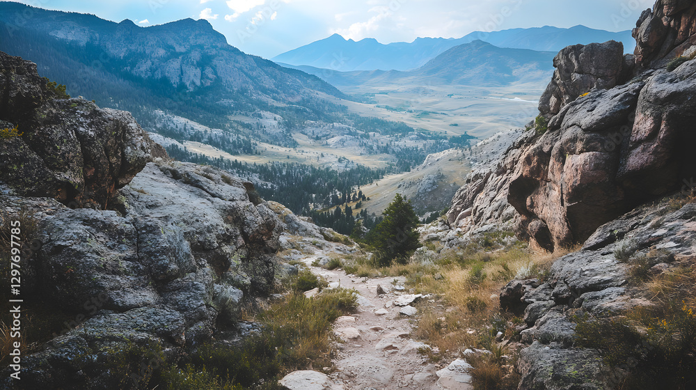 view of a mountain nature trail with rugged rocks and a wide valley ...