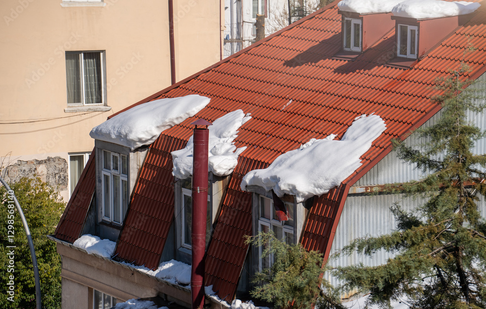 Heavy snow on rooftops in Batumi melting under the sun, creating ...