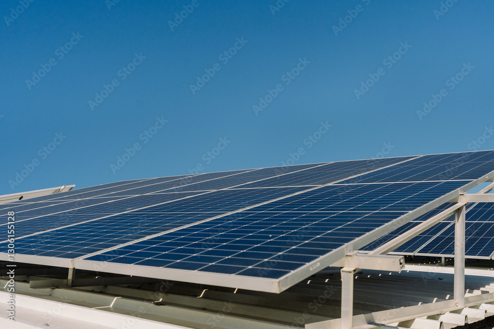 Solar panels are arranged in a grid formation on the rooftop ...