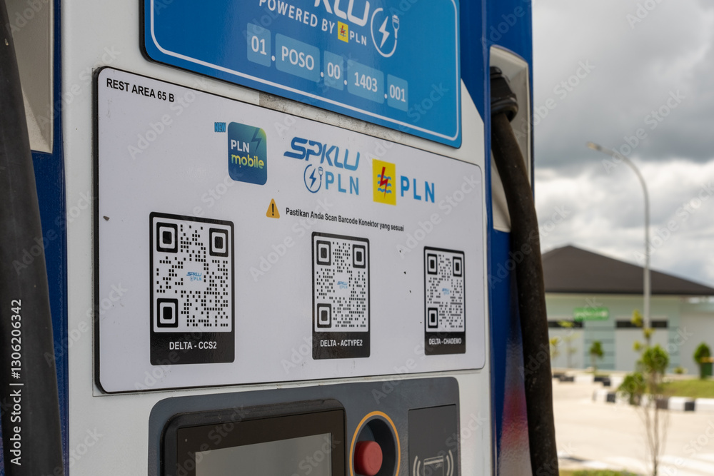 EV charging station with QR codes for activation, provided by PLN SPKLU. Modern electric vehicle ...